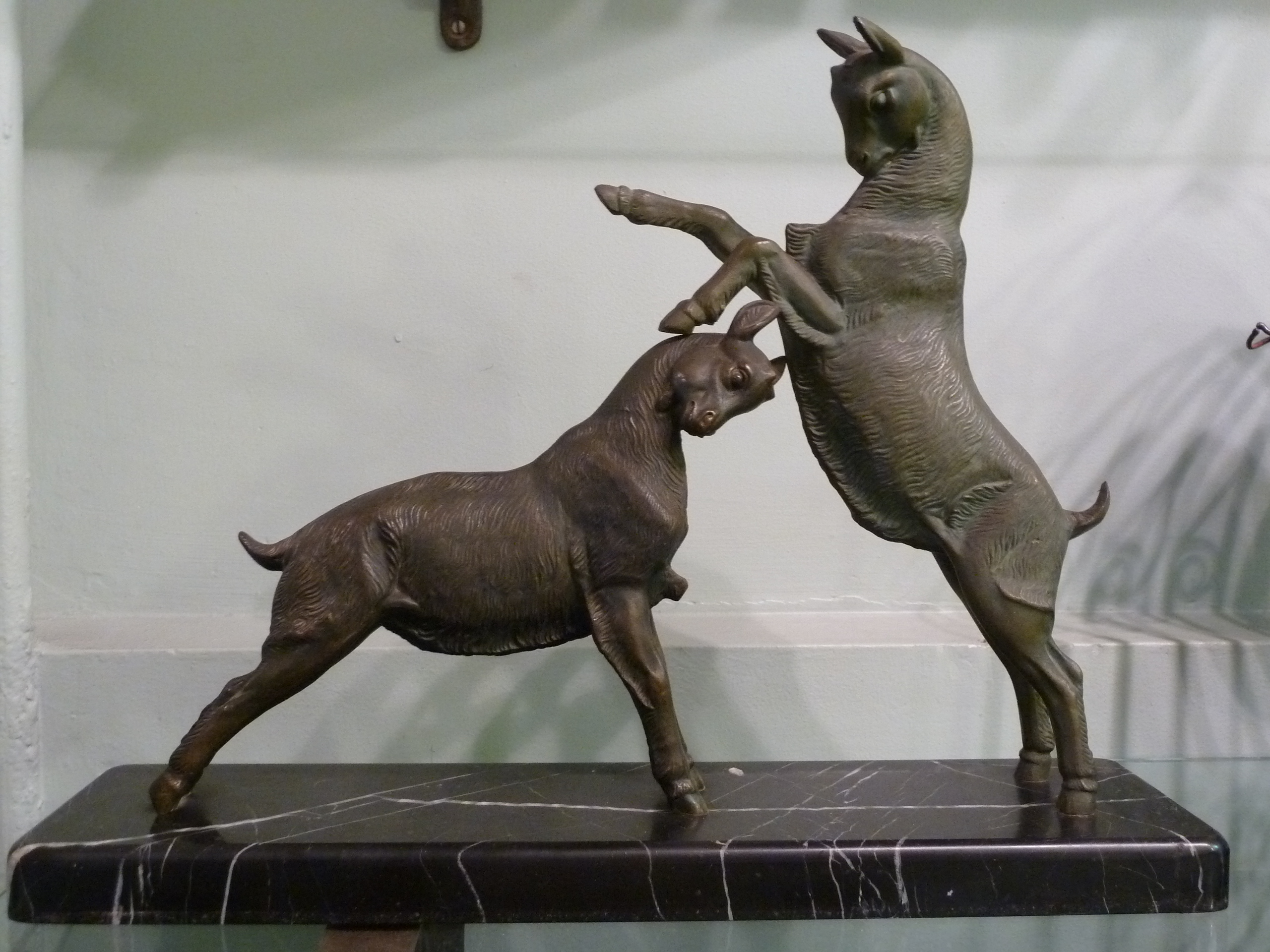 A spelter group of a pair of playful Billy Goats on a black marble base ...
